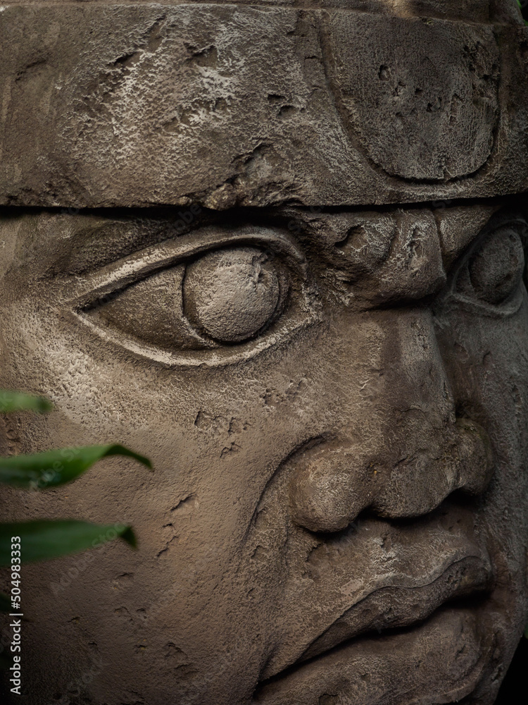 Olmec sculpture carved from stone. Mayan symbol - Big stone head statue ...