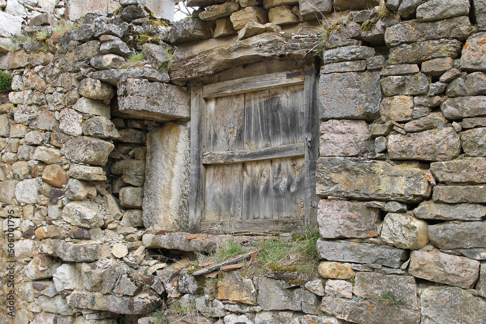 Wooden window in an old ruined building located in a mountainous area ...