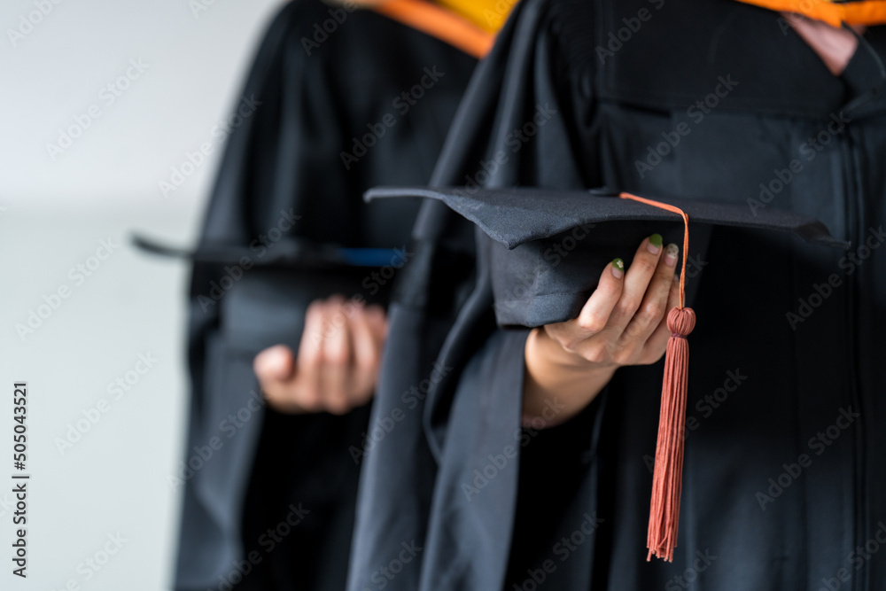 Student holding graduation caps during commencement Graduation cap in ...