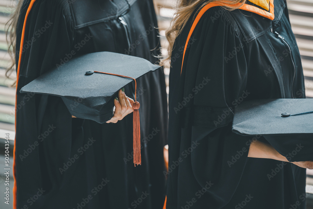 Student holding graduation caps during commencement Graduation cap in ...