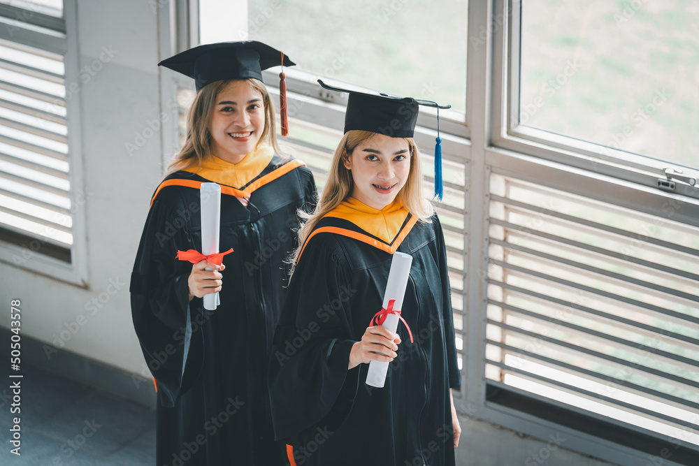 Student holding diploma degree certificate scroll during commencement ...