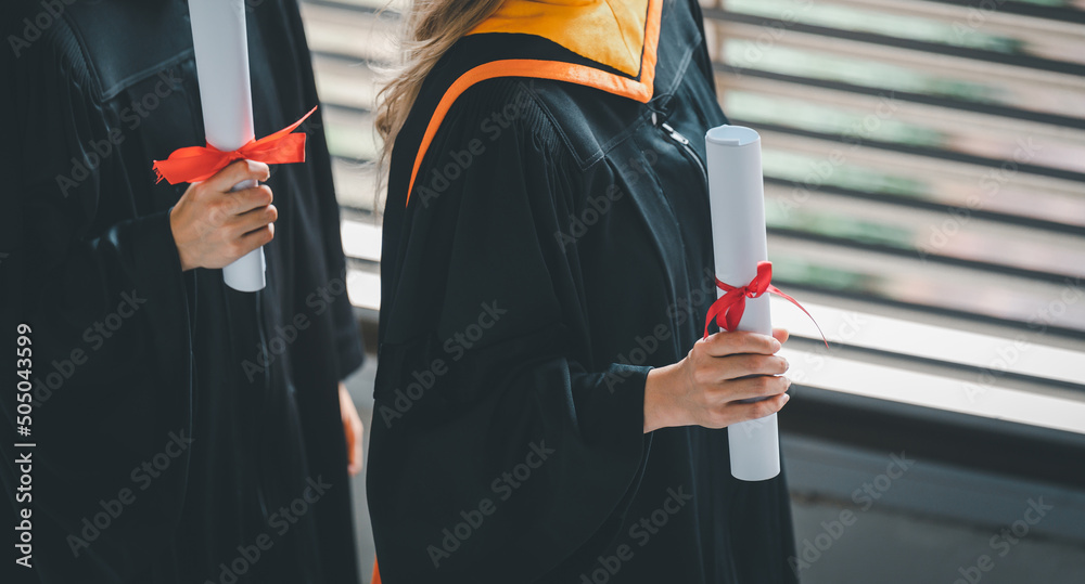 Student holding diploma degree certificate scroll during commencement ...