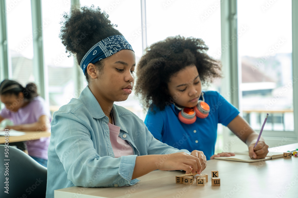 Children writing notes in classroom,African school child writing during ...