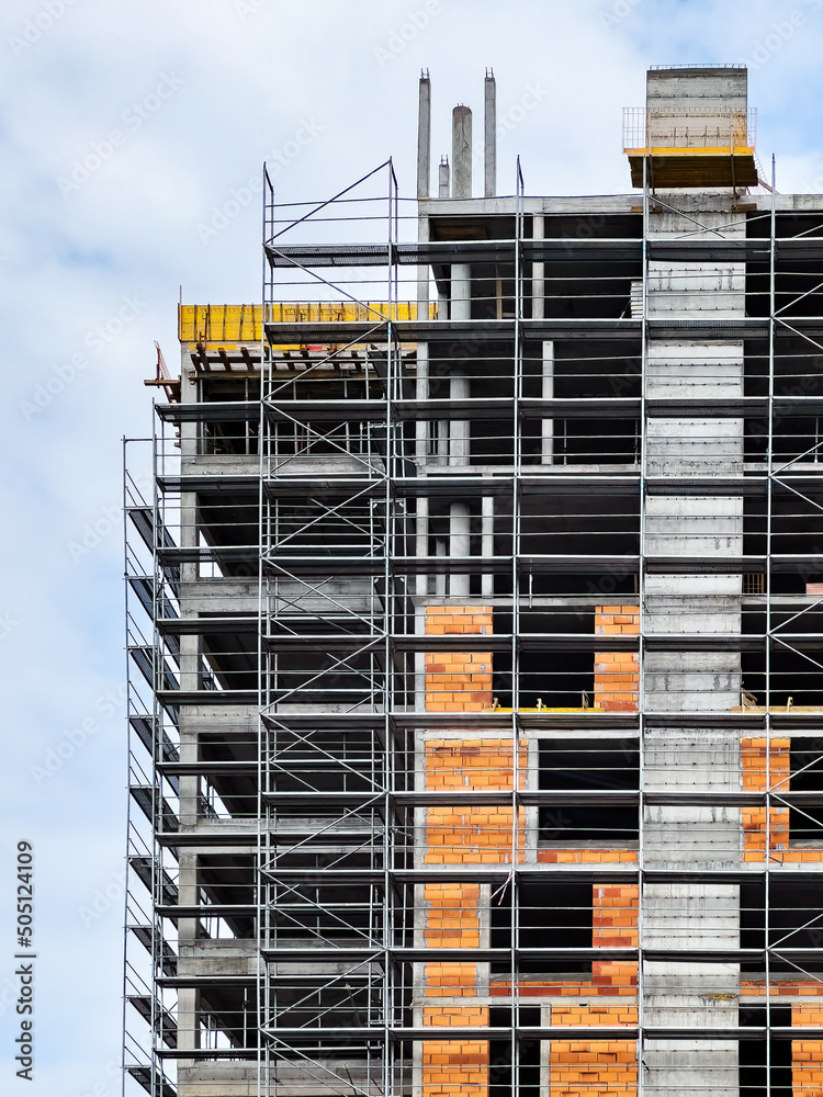 Apartment building construction site with scaffolding surrounding the ...