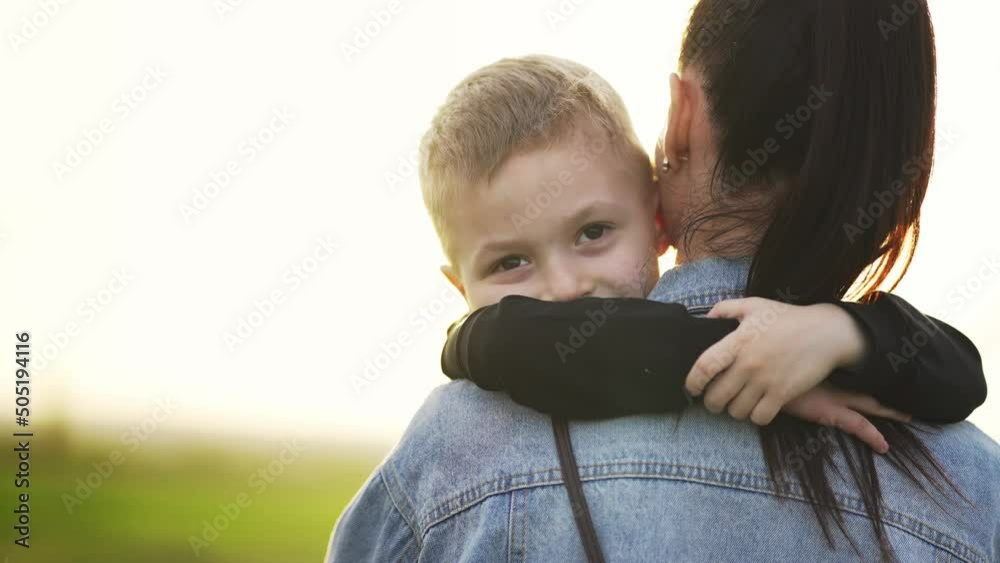 Happy harmonious family in the open air. The mother holds the child in ...