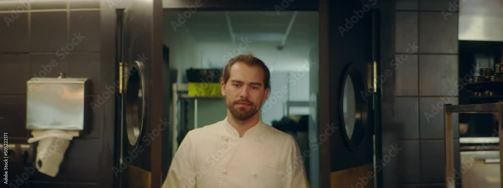TRACKING Caucasian male chef walking out of commercial restaurant ...