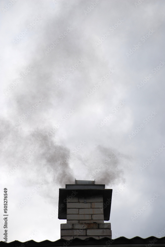 The chimney and which is the smoke. A white-brick chimney rises above a ...
