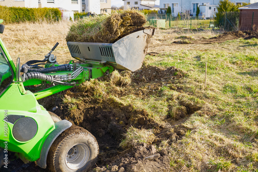 Traktor on the field. Mini traktor landscaping at home backyard. Diy ...