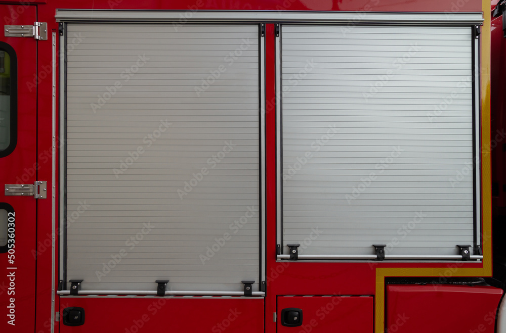 Fire engine roller shutters or roll-up doors. Fire brigade truck side ...