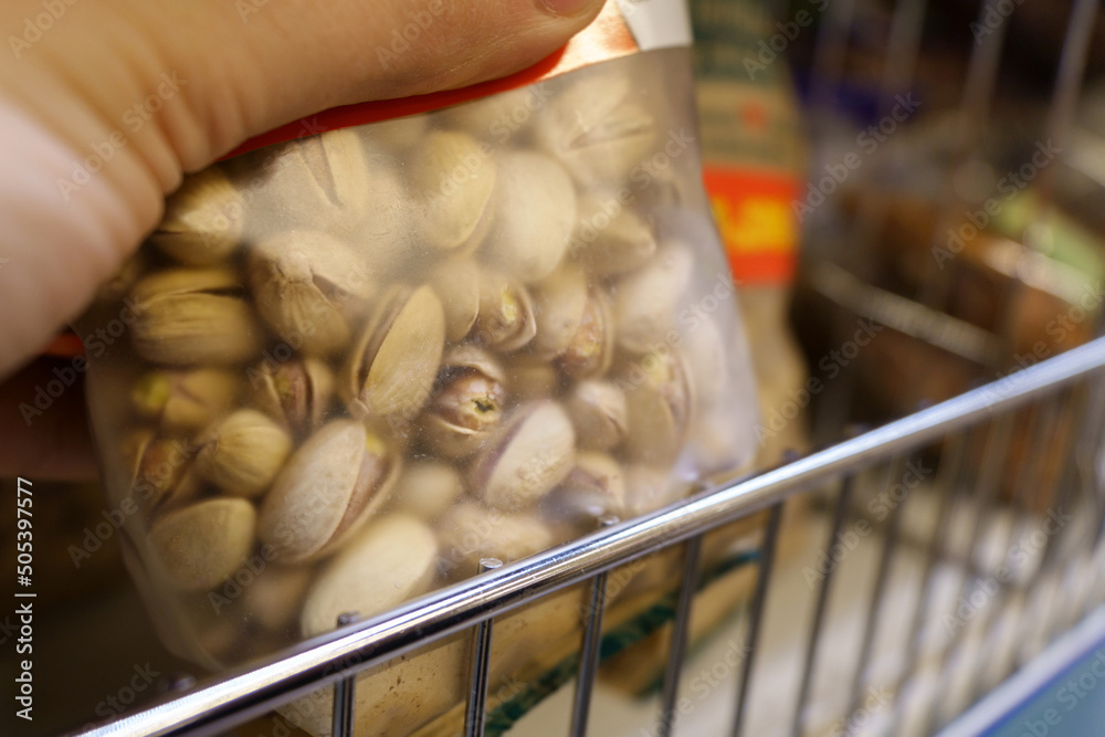 Pre packaged snacks pistachios nuts on the shelves of the hypermarket ...