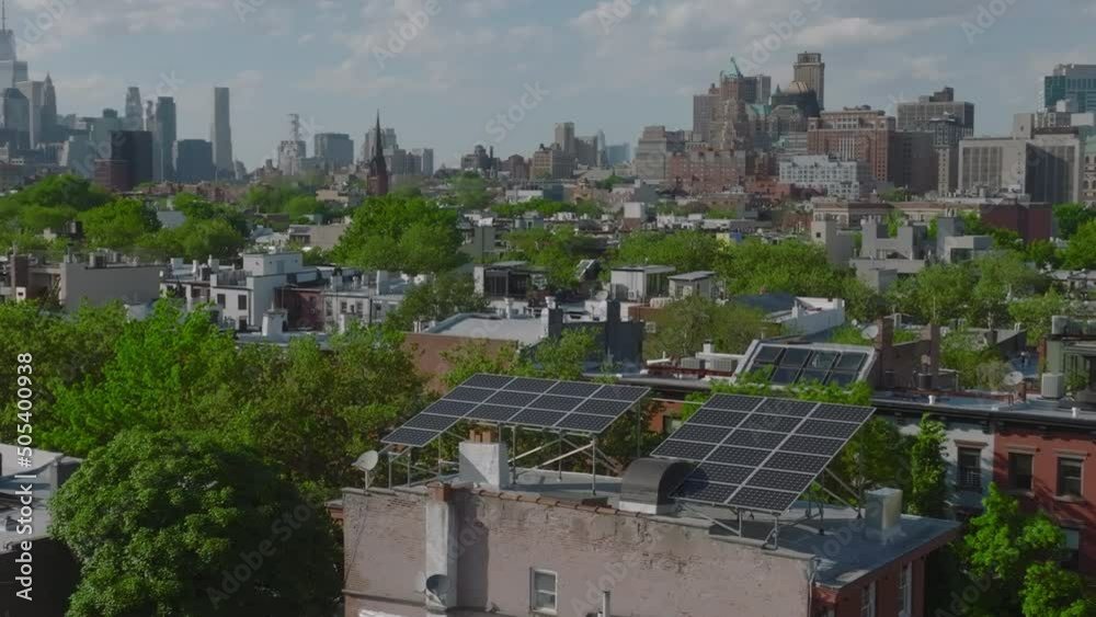 flying counter clockwise around rooftop solar panels with NYC skyline ...