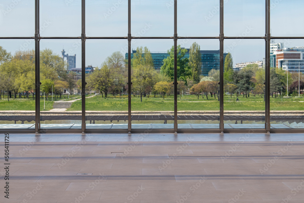 Empty modern interior with large windows and panoramic cityscape view ...