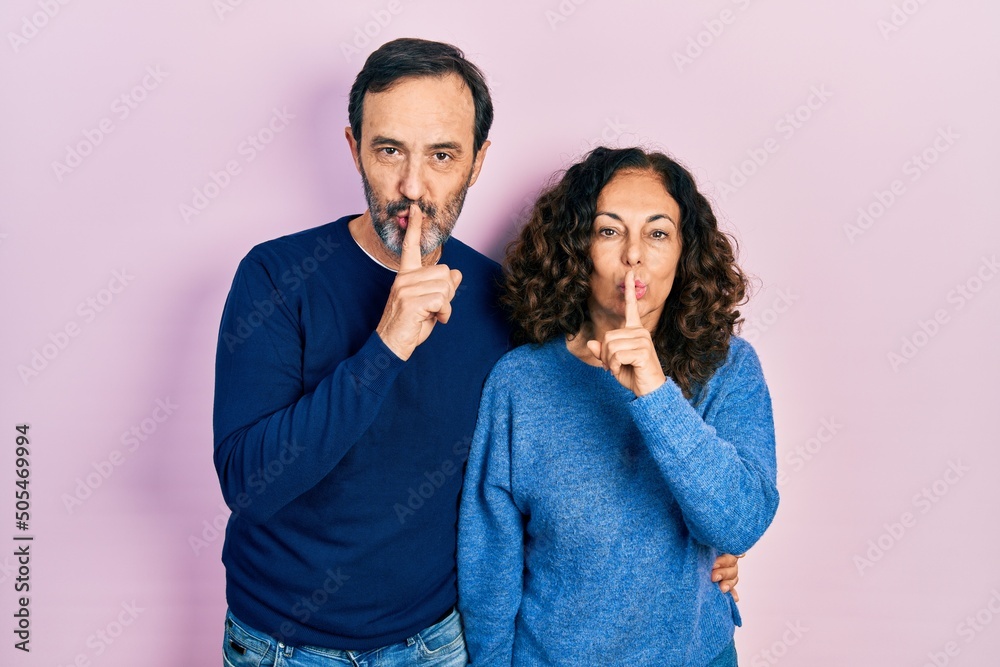 Middle age couple of hispanic woman and man hugging and standing ...