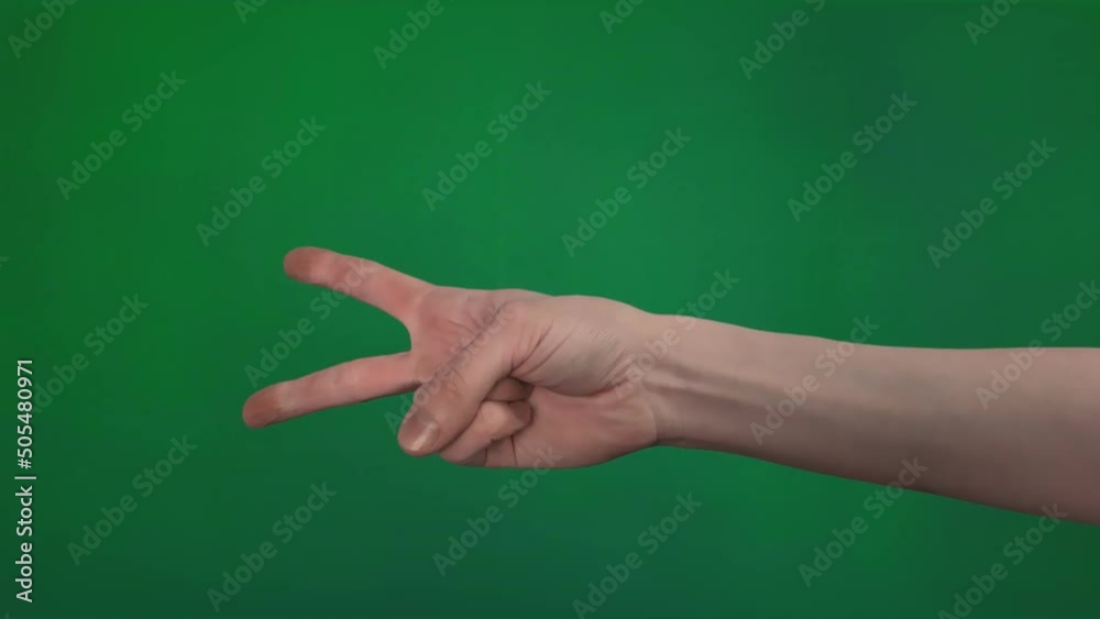 Slow motion Rock paper scissors hand game. one hand side view. Green ...