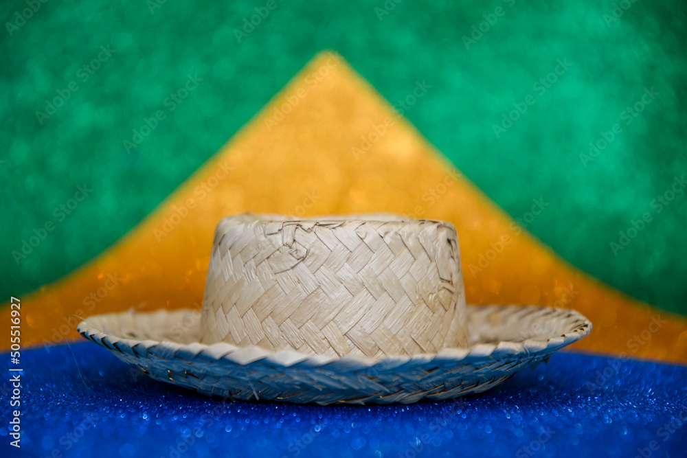Straw hat on a bright green yellow and blue background. Traditional ...
