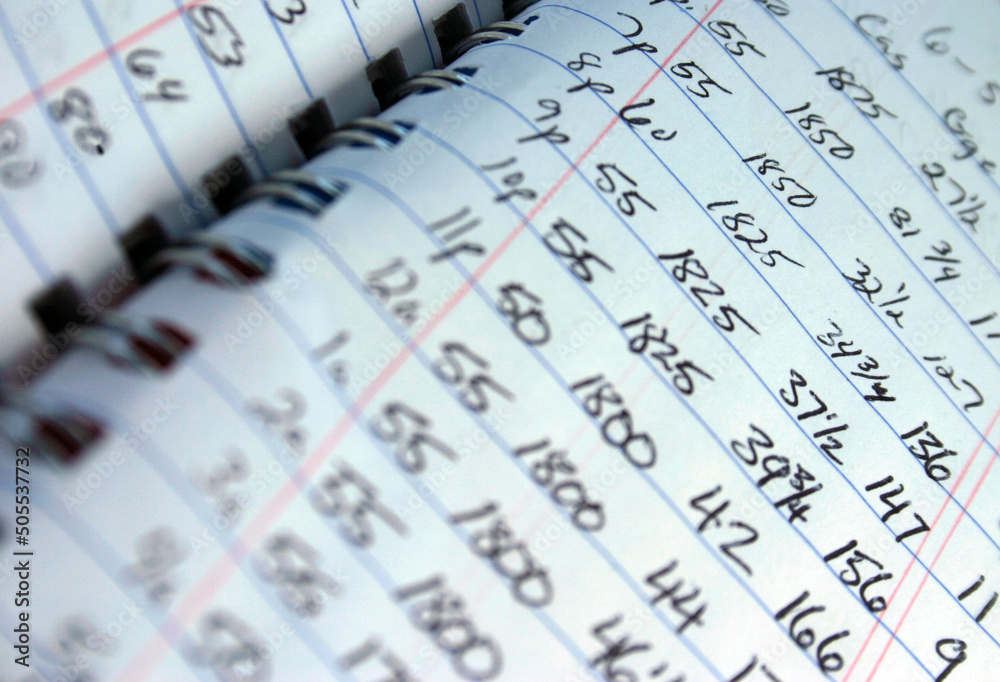 List of hand written numbers documented in a spiral bound booklet Stock ...