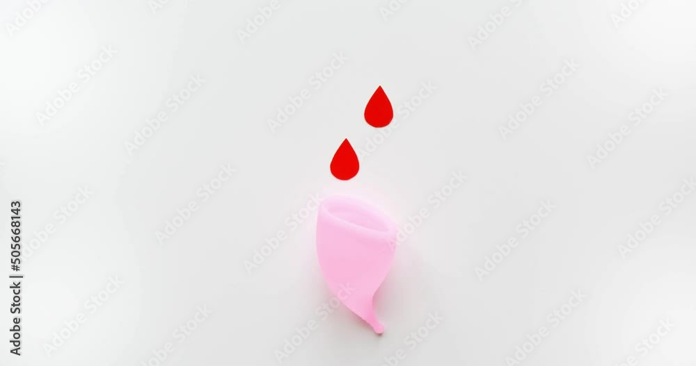 Drops of blood cut out of paper drip into the menstrual cup. Looped 4K ...