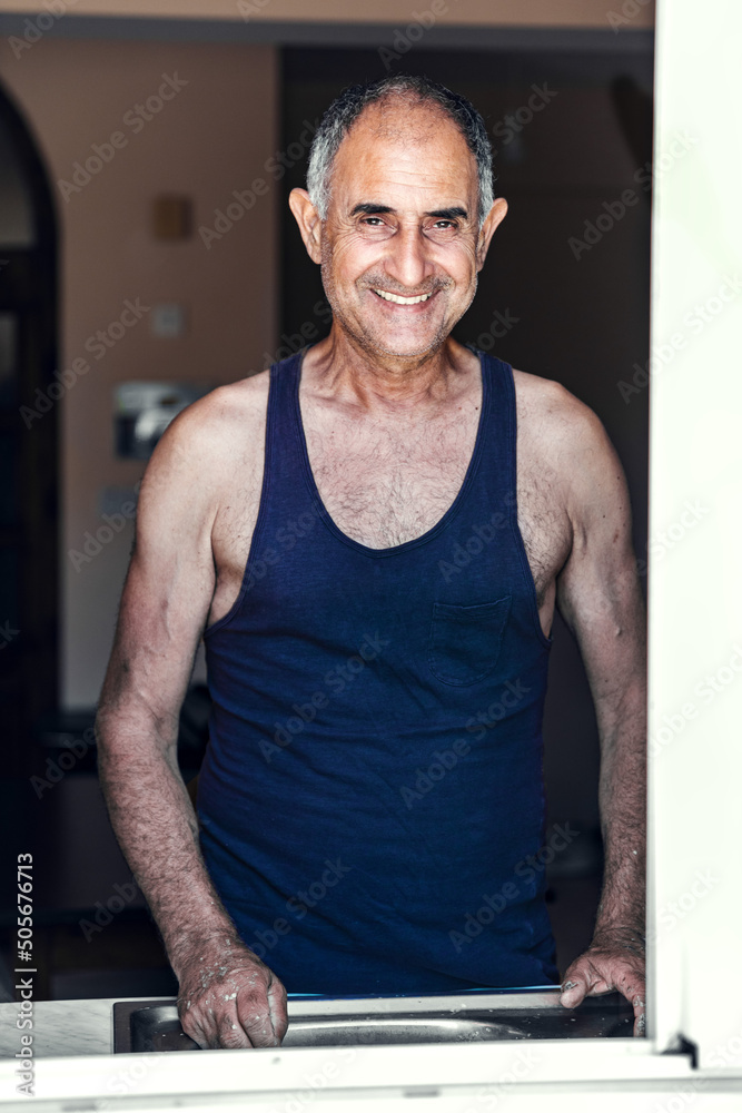 Portrait of smiling aged 60 years old man dressed in blue shirt. Front ...