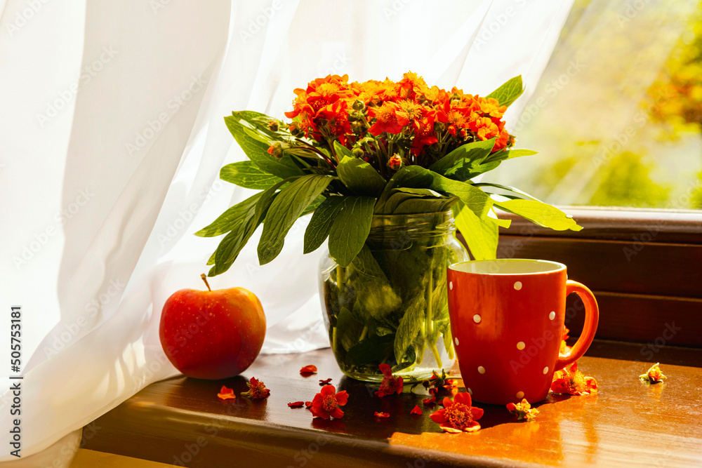Bouquet of orange spring flowers on the window in the sunlight. Orange ...