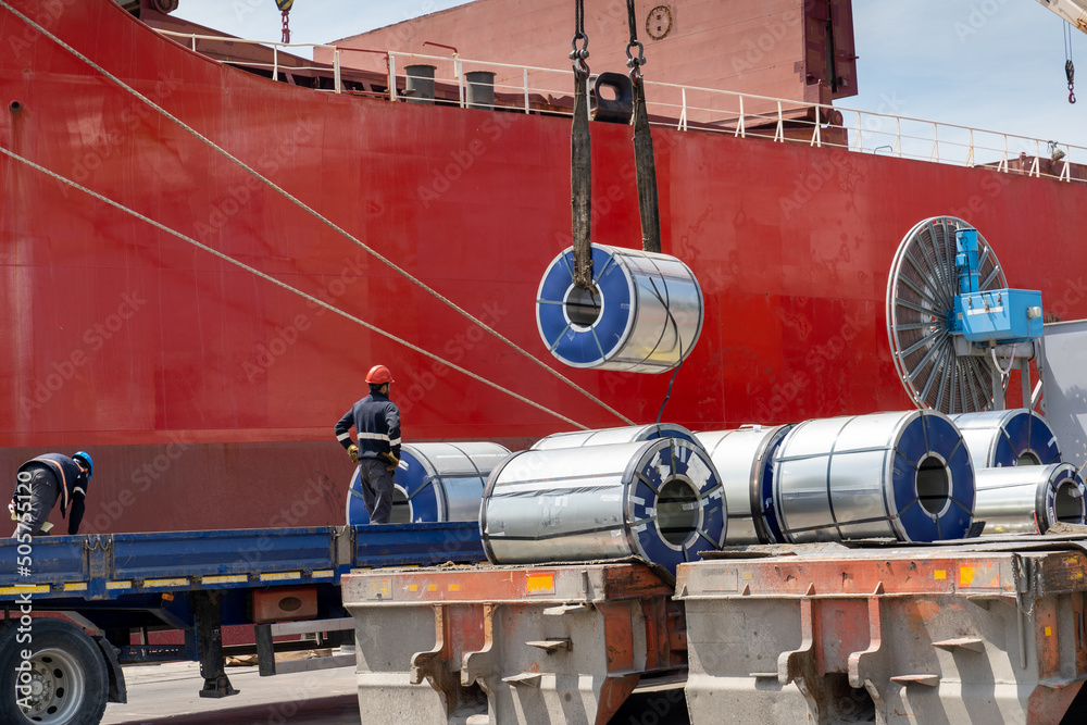 Packaged coils, galvanized steel and large tin rolls are loaded onto ...