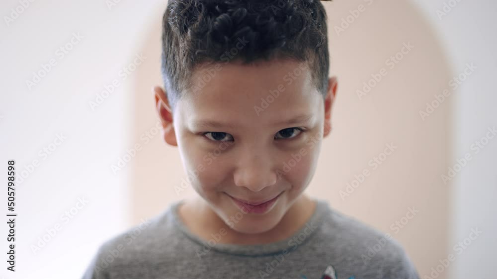 Cute 10 year old boy tries serious grumpy face but breaks expression to ...