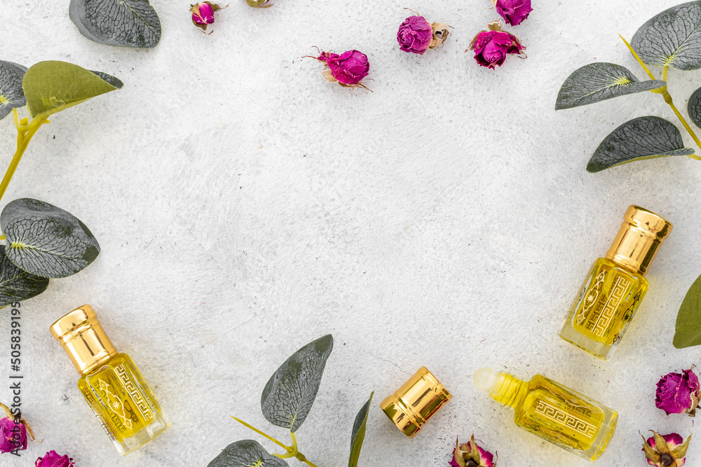 Perfume essential oil in glass bottles, top view. Traditional Arabian ...