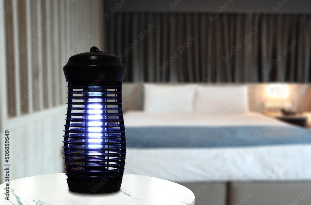 an insects mosquito electric blue light killer lamp is put on the white ...