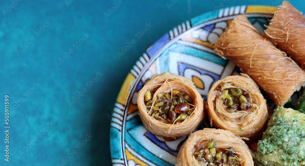 Authentic Middle East dessert. Close up photo of baklava on a blue ...
