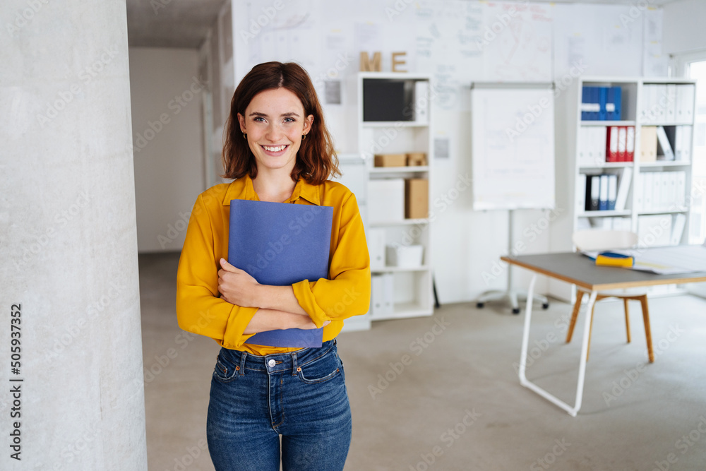 Young student stands in an office with her application documents and ...
