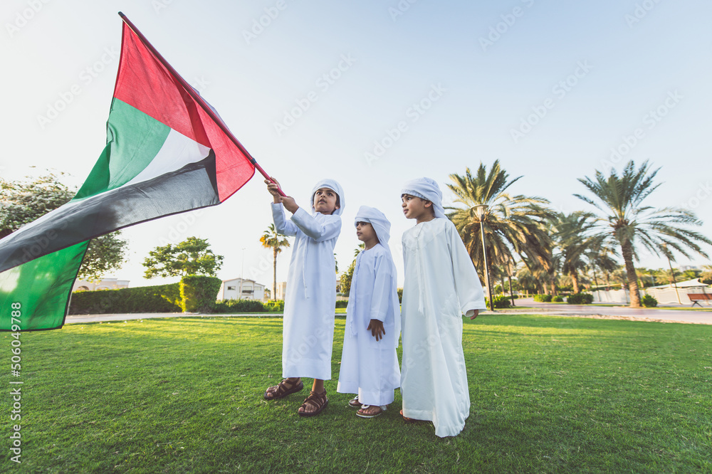 Children playing together in Dubai in the park. Group of kids wearing ...