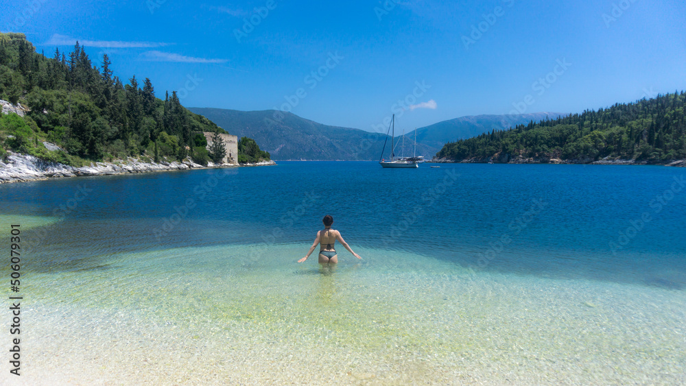 Beautiful sensual young girl in bikini. Crystal blue water. Pacific ...