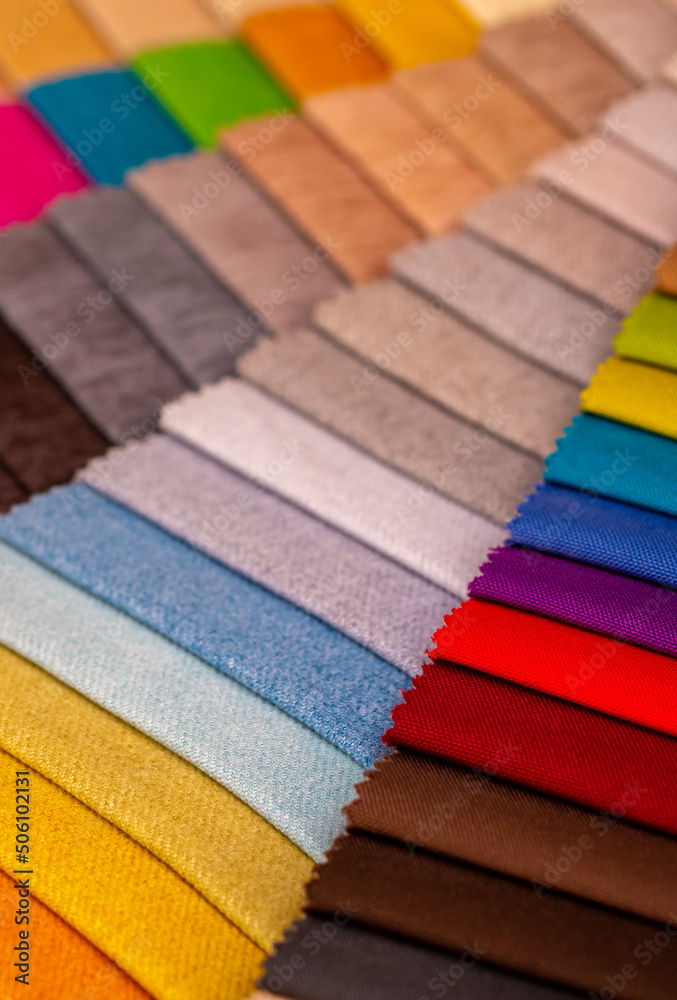 Fabric swatches in different colors are stacked for selection. A ...