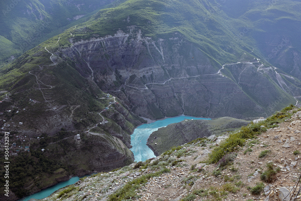 boat sails along the blue-green Sulak River. Sulak canyon is one of the ...