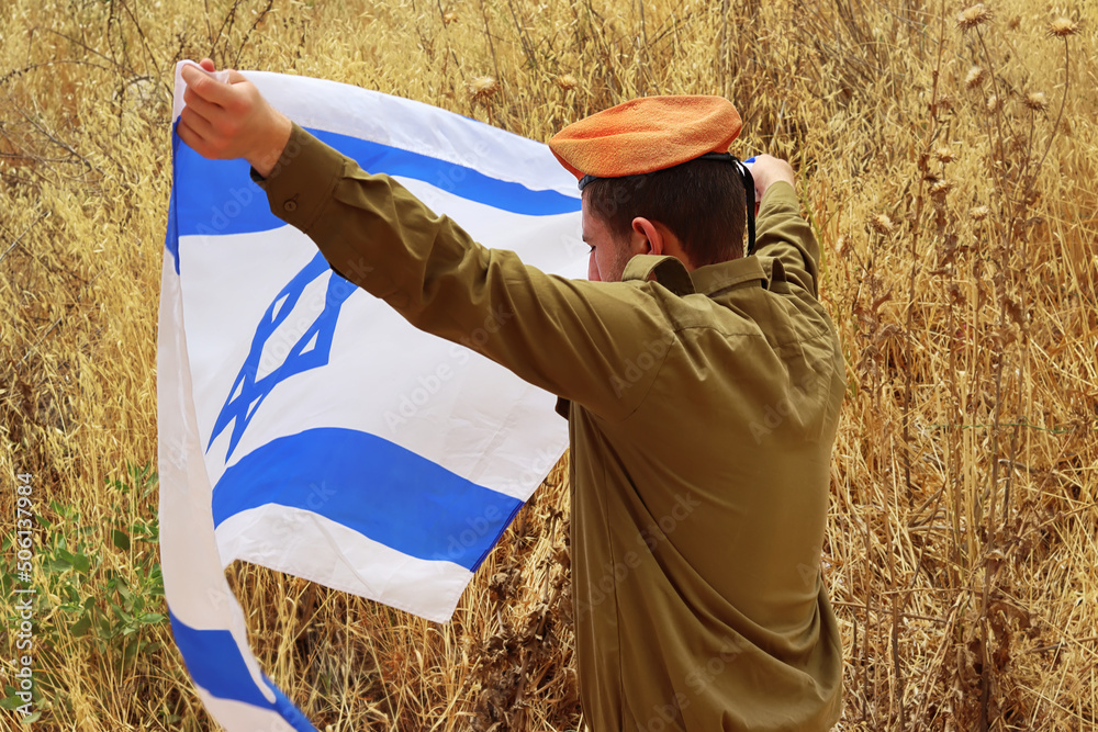 Soldier of the Israeli Army with a blurred Flag of Israel. Photo for ...