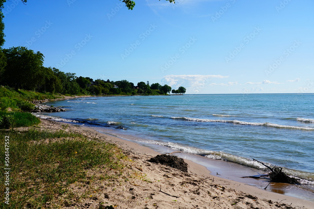 Sandy beach is on the shoreline of Lake Michigan in Sheboygan ...