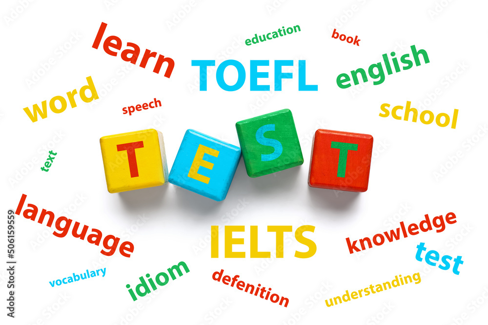 Text TEST made of wooden cubes and different words on white background ...