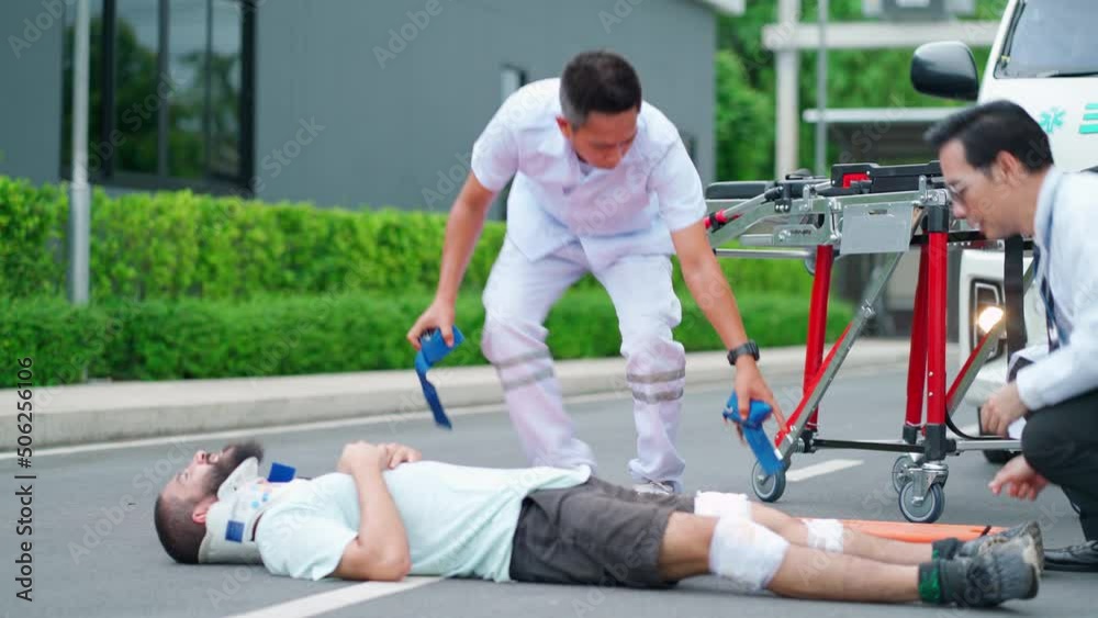 Injured man lying on the road and feeling painful. Ambulance come on ...