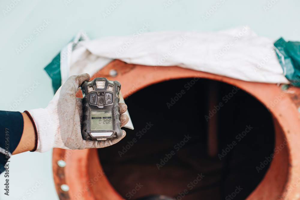 Worker hand holding gas detector inspection safety gas testing at front ...