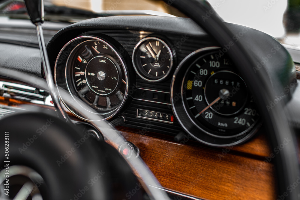 Classic, vintage dash with visible instrument cluster of a luxury motor ...