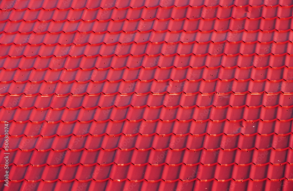 Red corrugated metal profile roof installed on a modern house. The roof ...