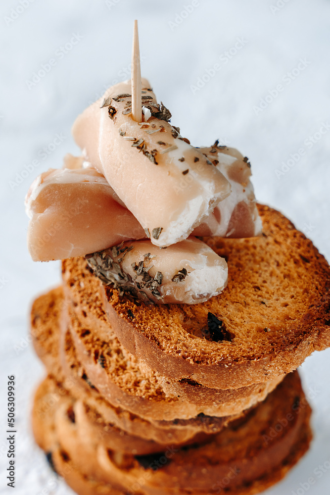 Food background. A tower of crispy toast with olives and ham and cream ...