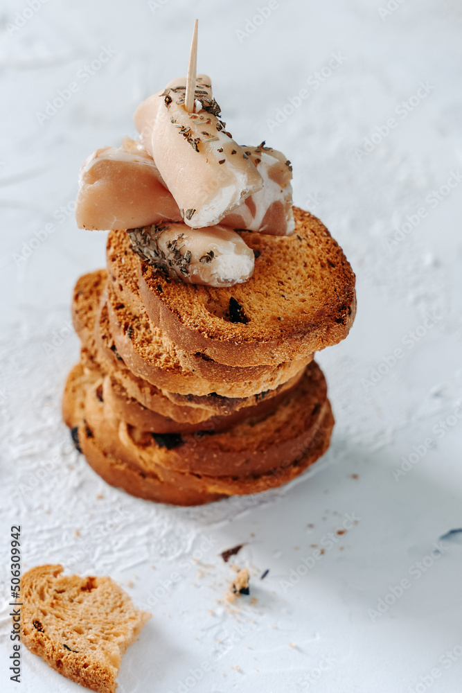 Food background. A tower of crispy toast with olives and ham and cream ...