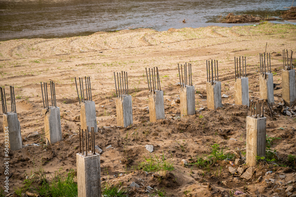 Rows of concrete piles foundation drilling in the ground in ...