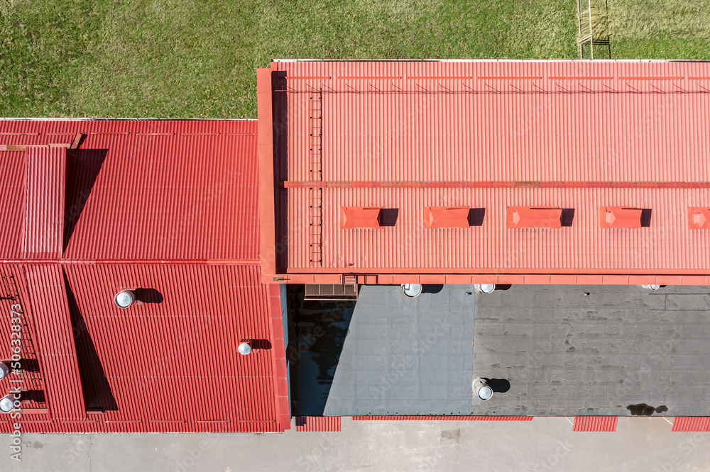 red metal roofing of industrial building. corrugated metal roof with ...