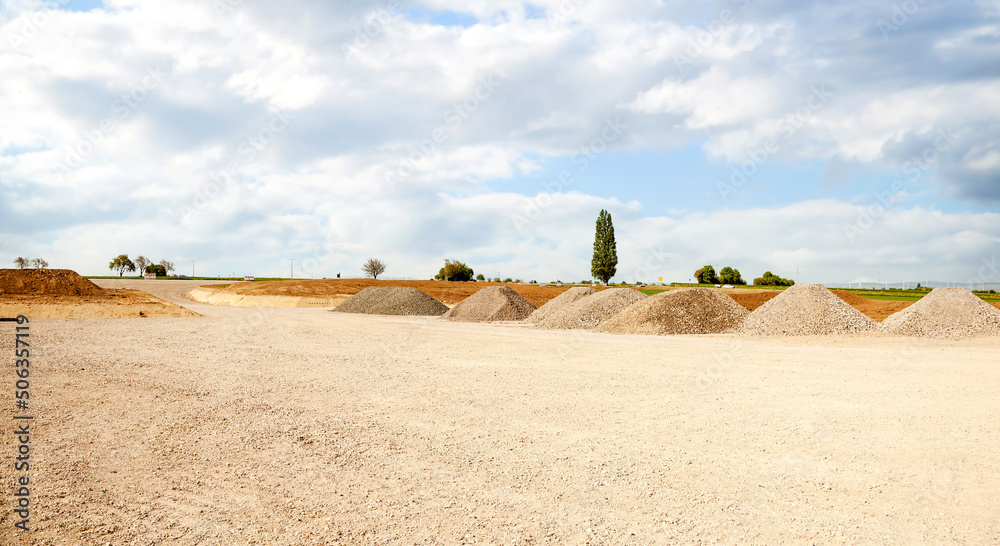 entrance construction site, driveway of building site. Pile of sand and ...