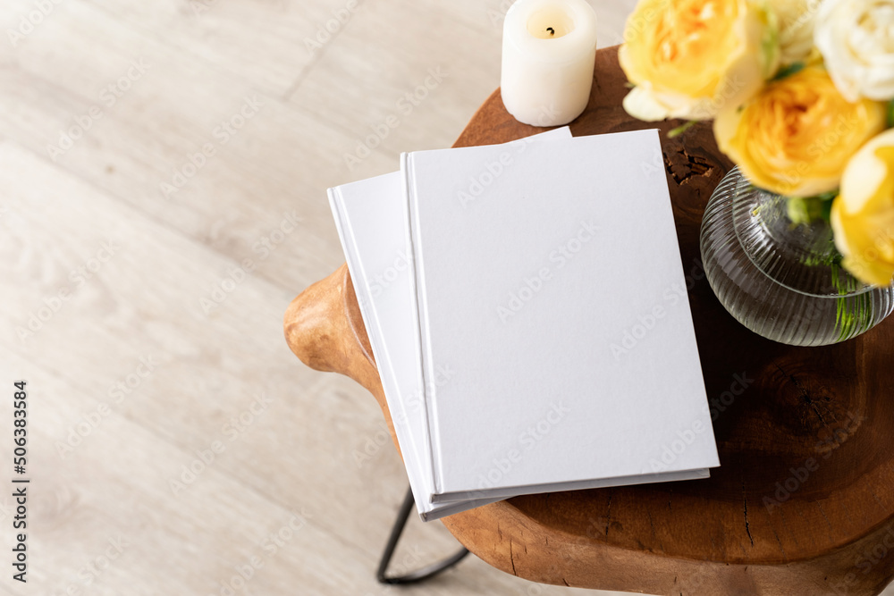 White book blank cover mockup on stylish wooden coffee table with roses ...