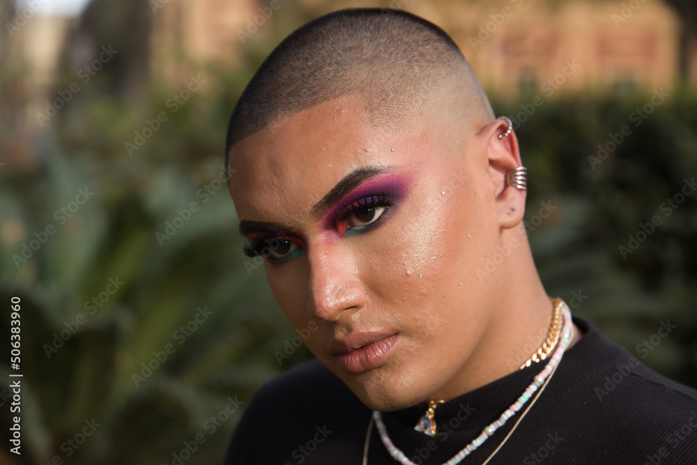 Portrait of non-binary person, young and South American, heavily make ...