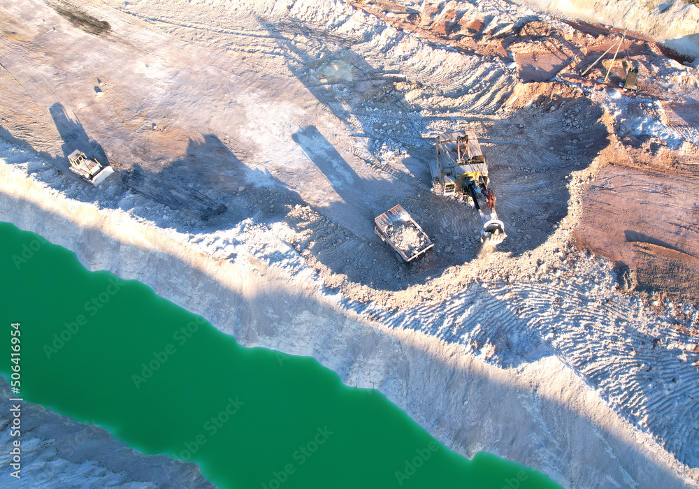 Excavator load limestone in mining truck in open pit mine. Haul truck ...