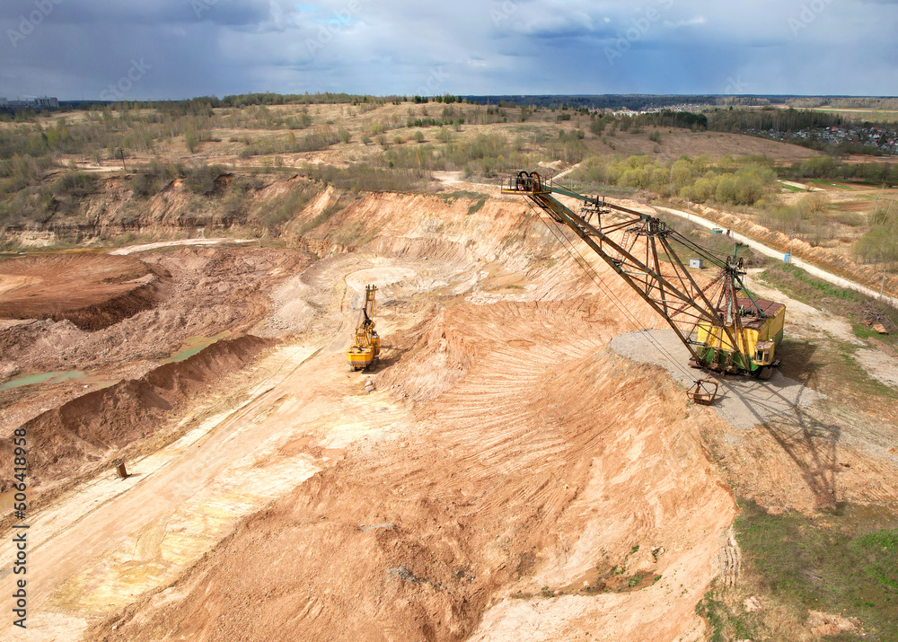 Walking dragline excavator in open pit on dolomite development. Big ...