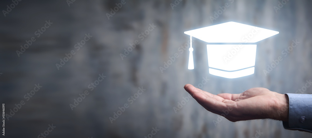 Man holding graduation cap symbol. Education Stock Photo | Adobe Stock